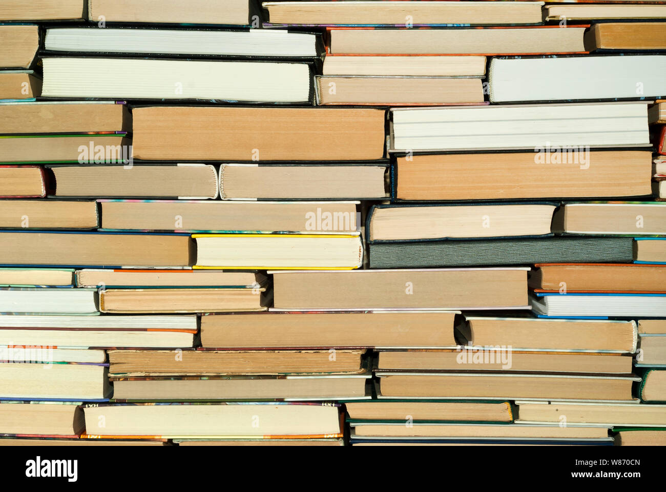 background - a wall composed of books of different sizes Stock Photo ...