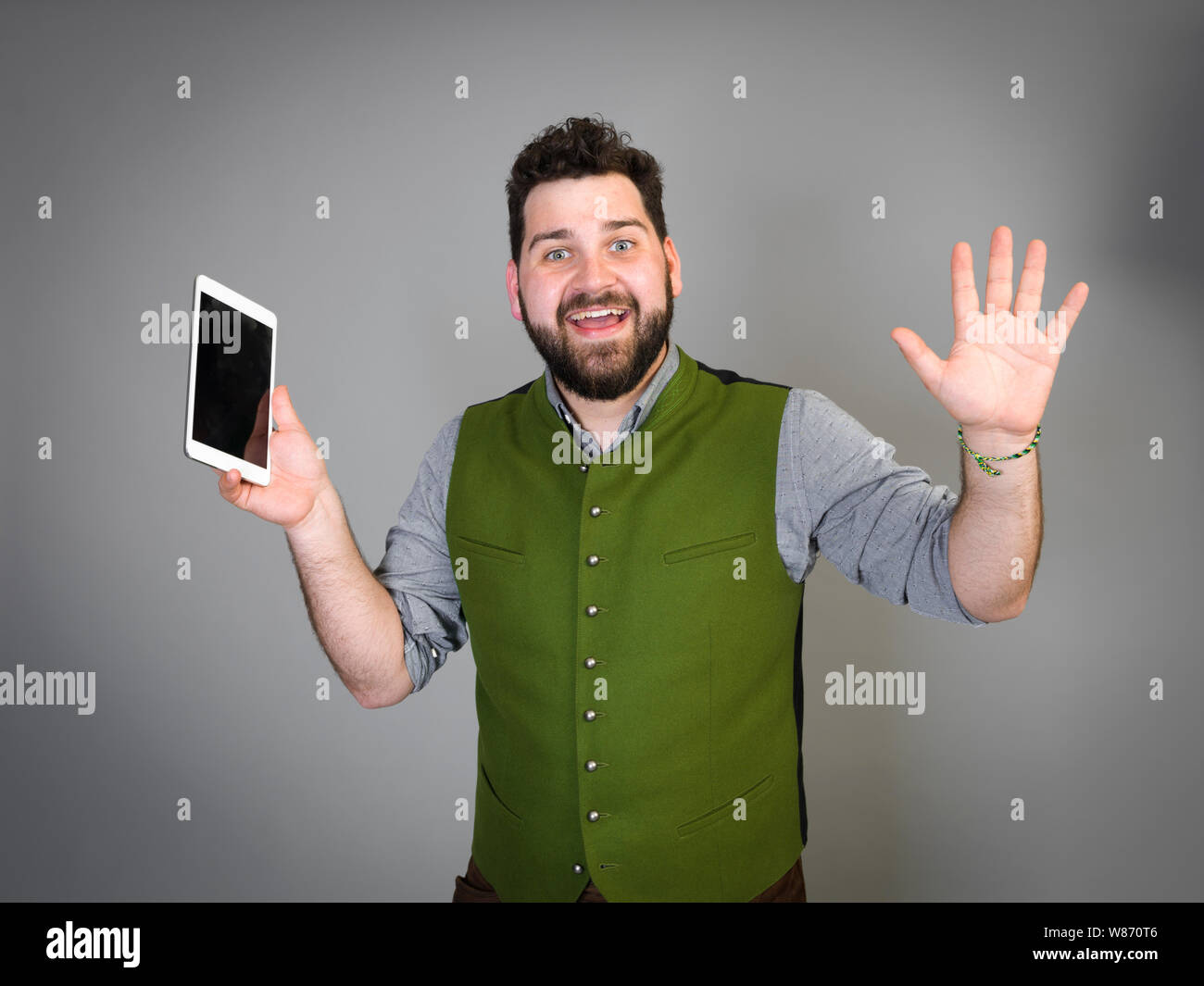 young and cool austrian man with black hair and beard in traditional ...