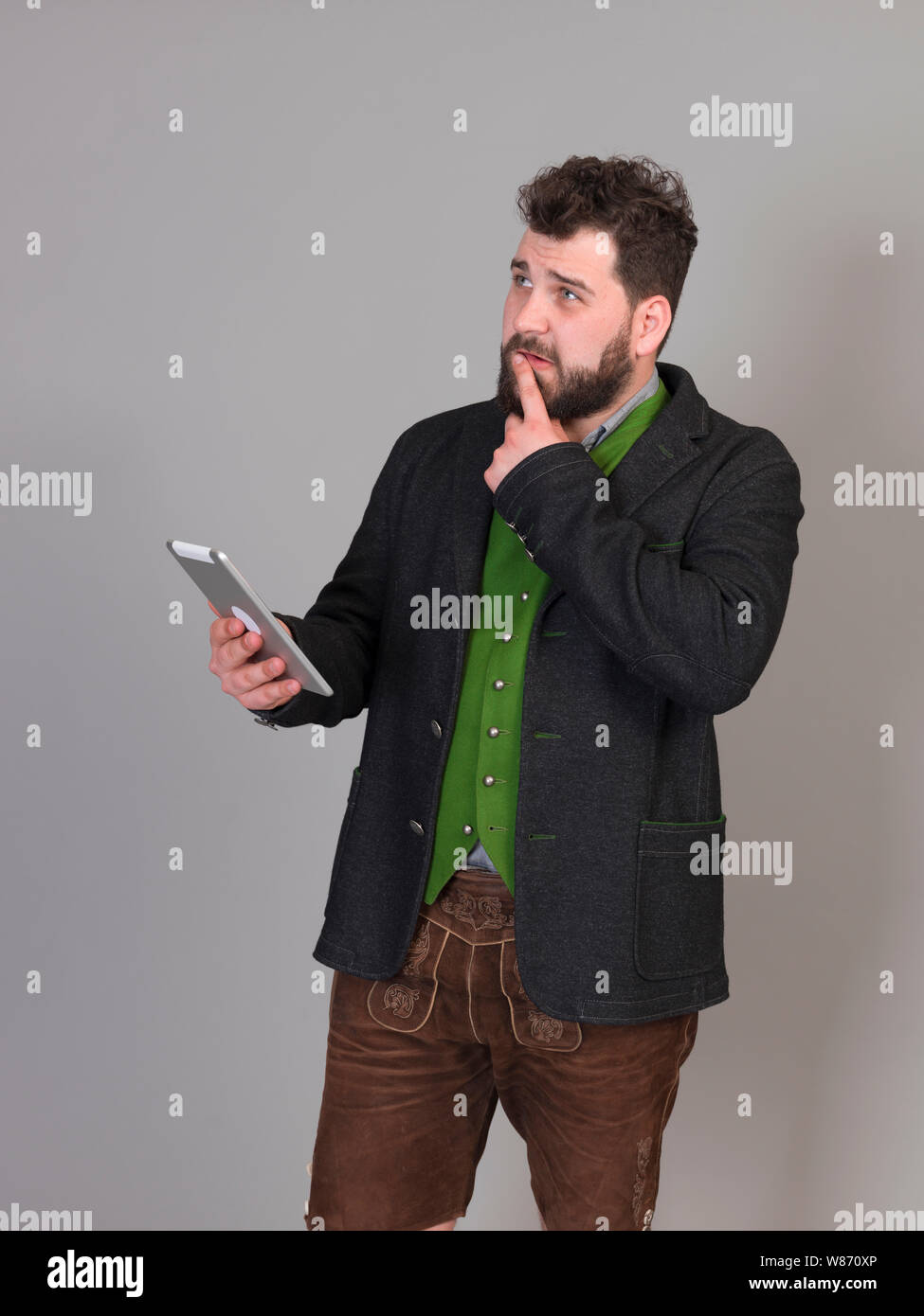 young and cool austrian man with black hair and beard in traditional ...