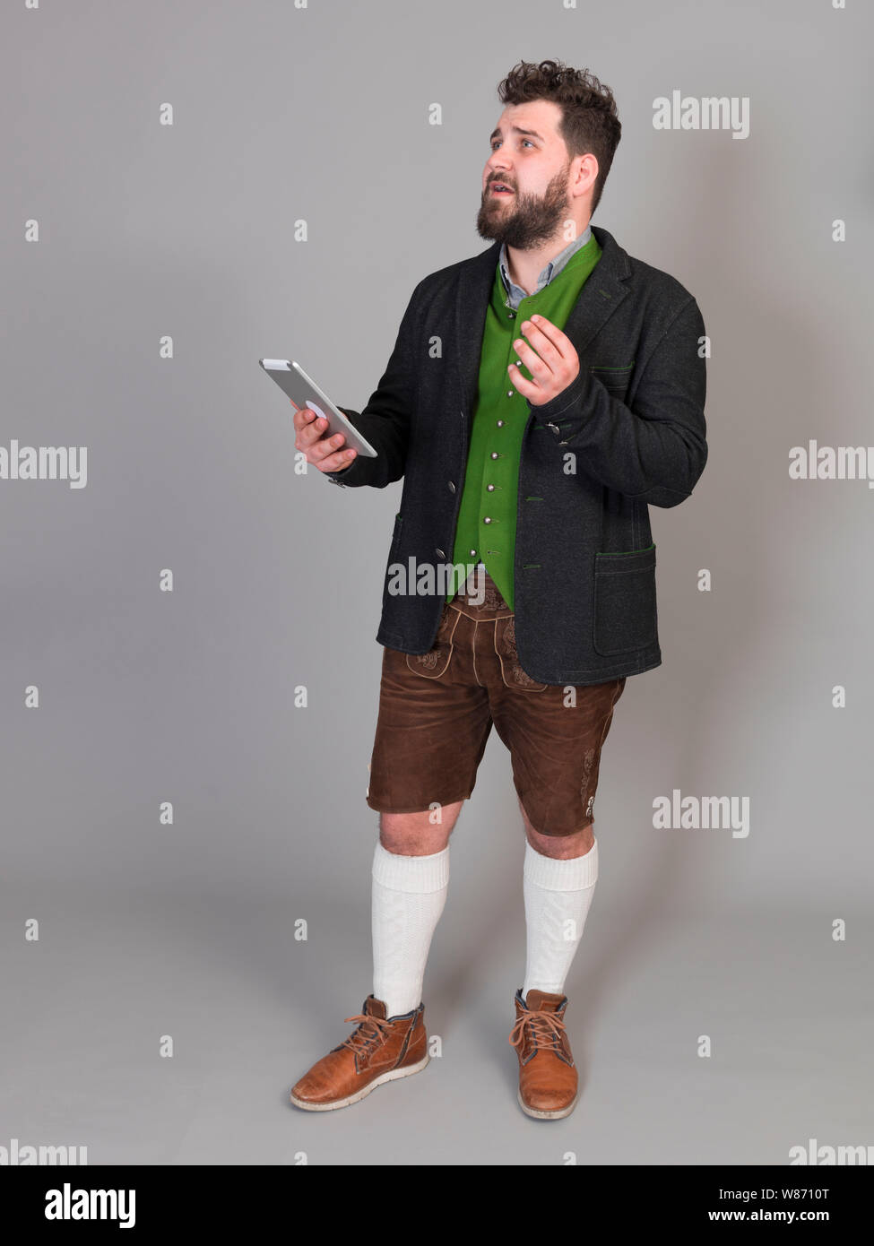 young and cool austrian man with black hair and beard in traditional ...