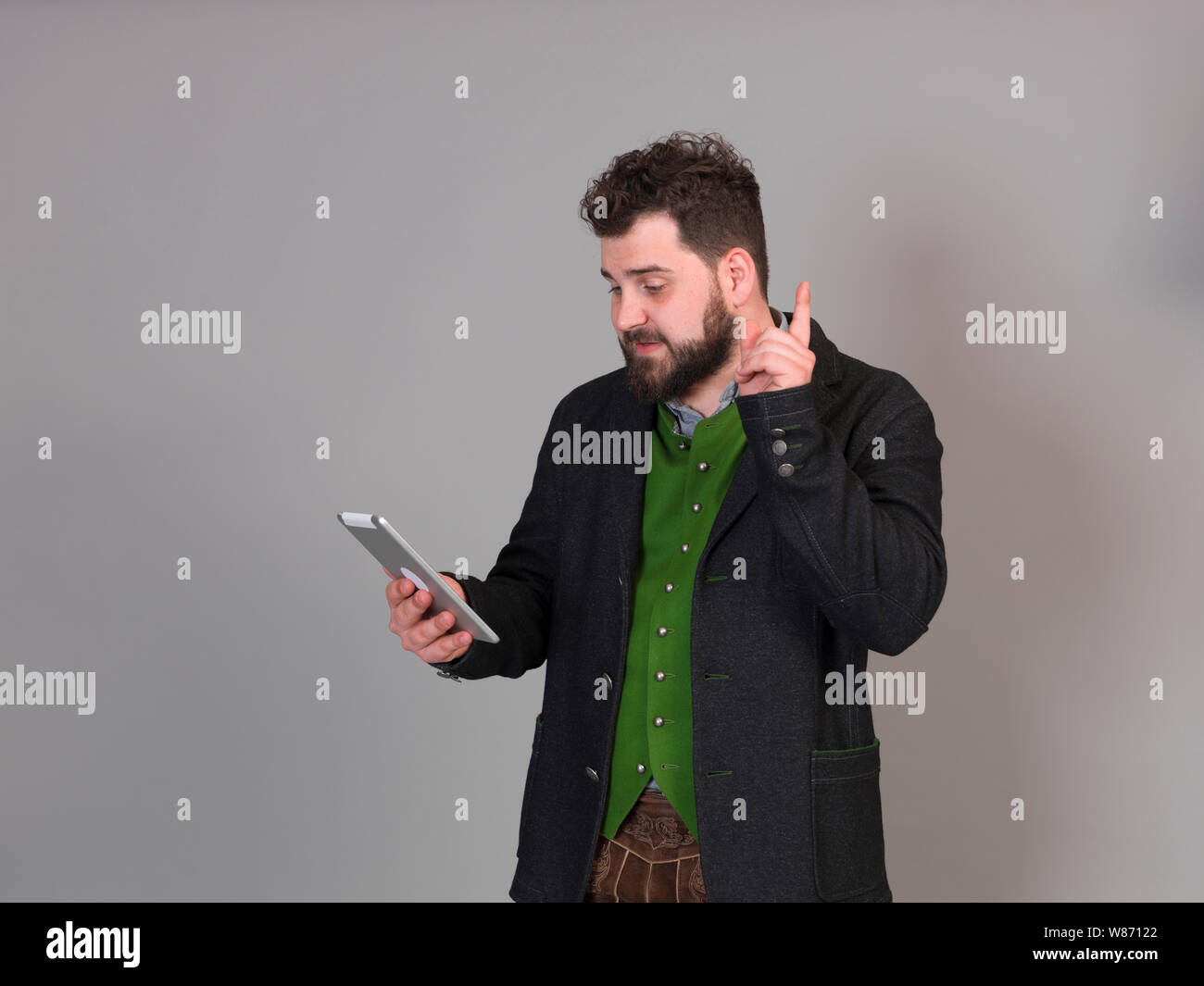 young and cool austrian man with black hair and beard in traditional ...