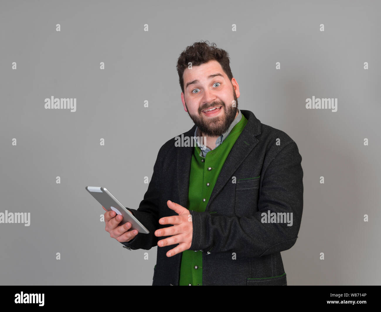 young and cool austrian man with black hair and beard in traditional ...