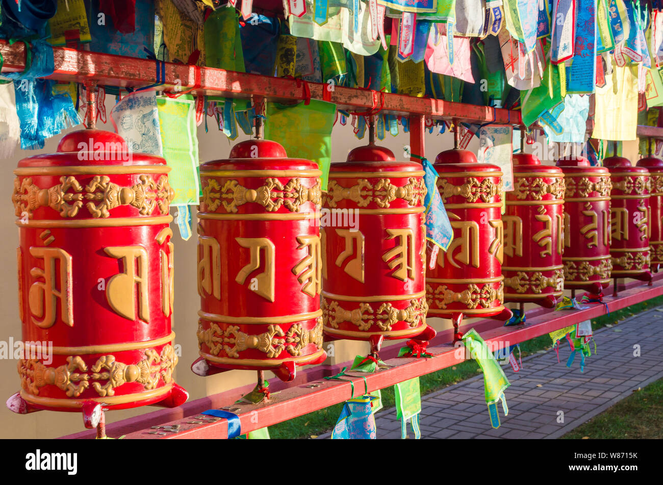 Buddhist prayer wheels in Buddhist Temple Datsan Gunzechoyney Stock Photo - Alamy