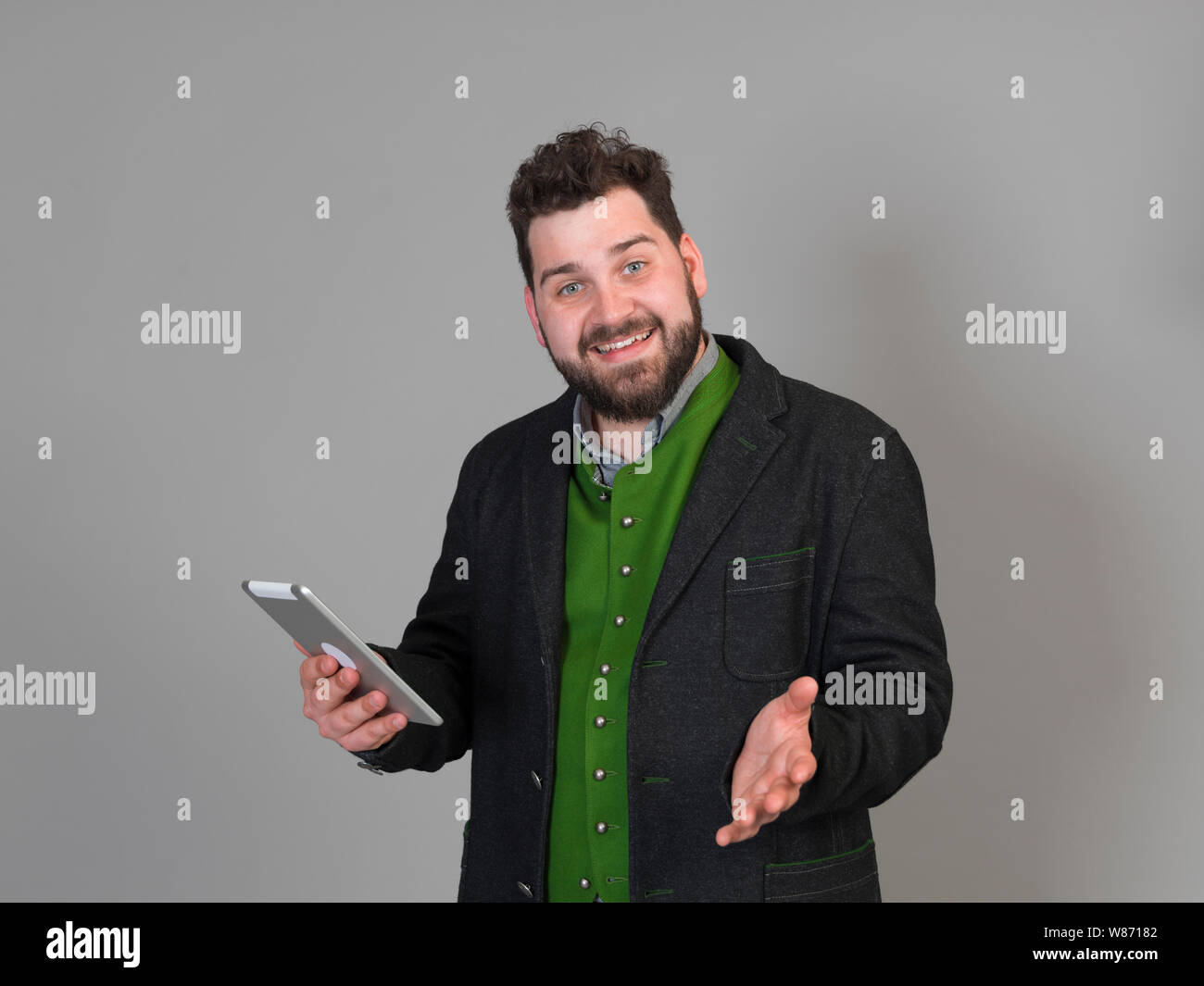 young and cool austrian man with black hair and beard in traditional ...