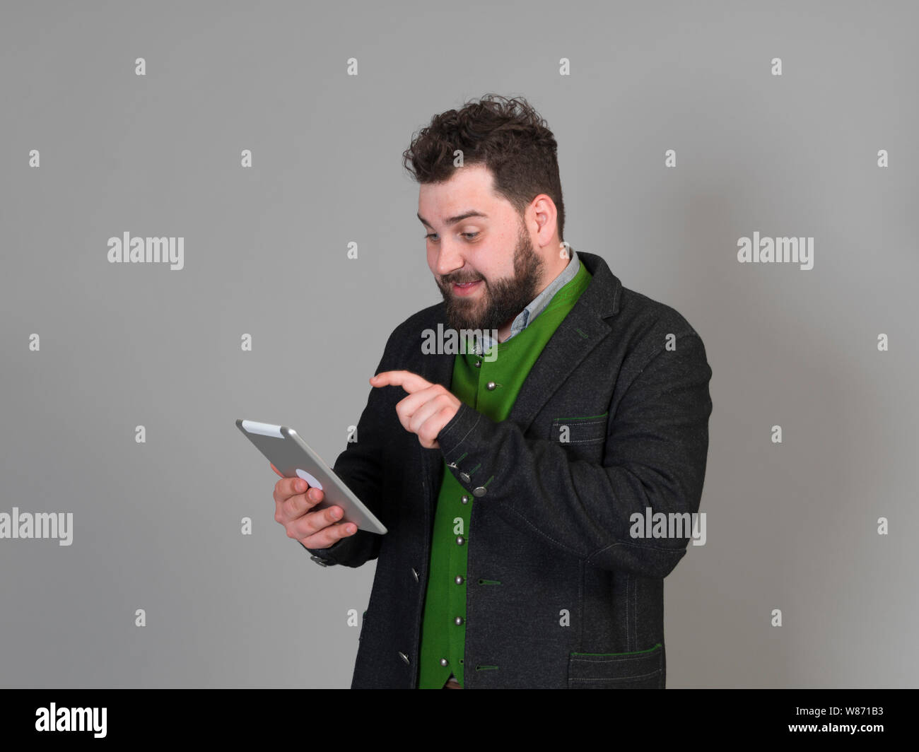 young and cool austrian man with black hair and beard in traditional ...