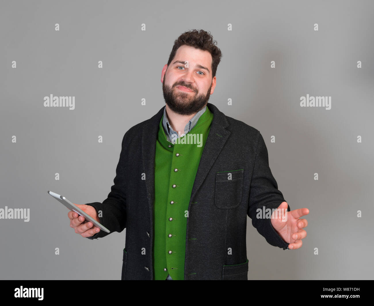 young and cool austrian man with black hair and beard in traditional ...