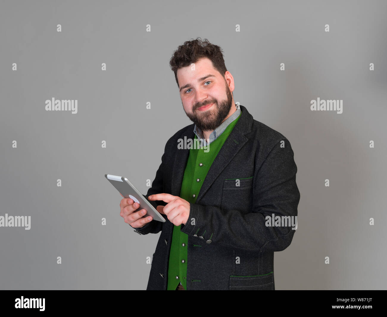 young and cool austrian man with black hair and beard in traditional ...