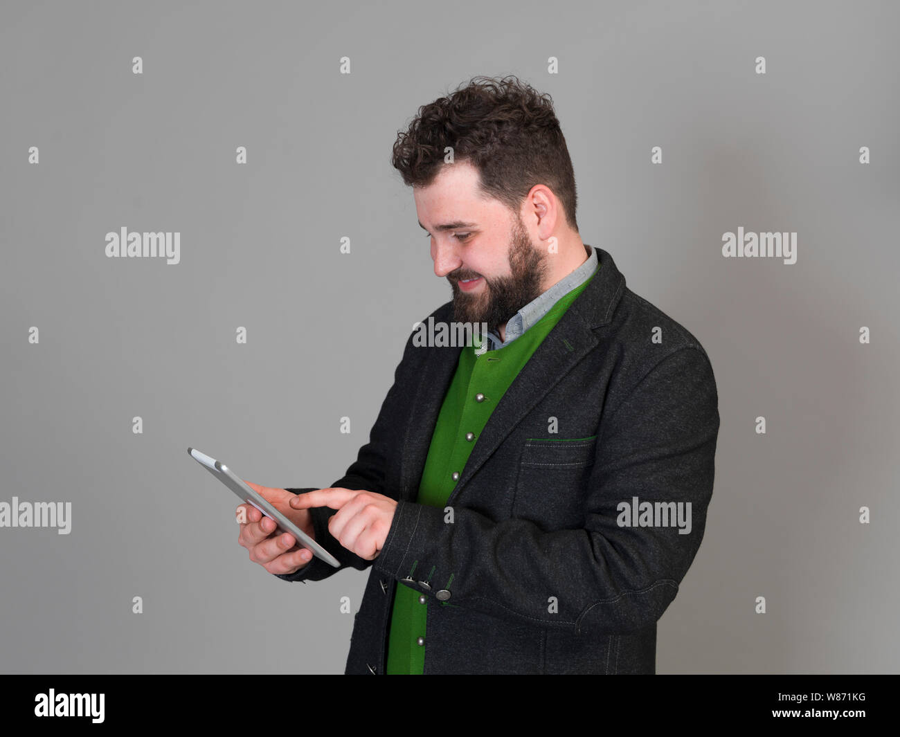 young and cool austrian man with black hair and beard in traditional ...