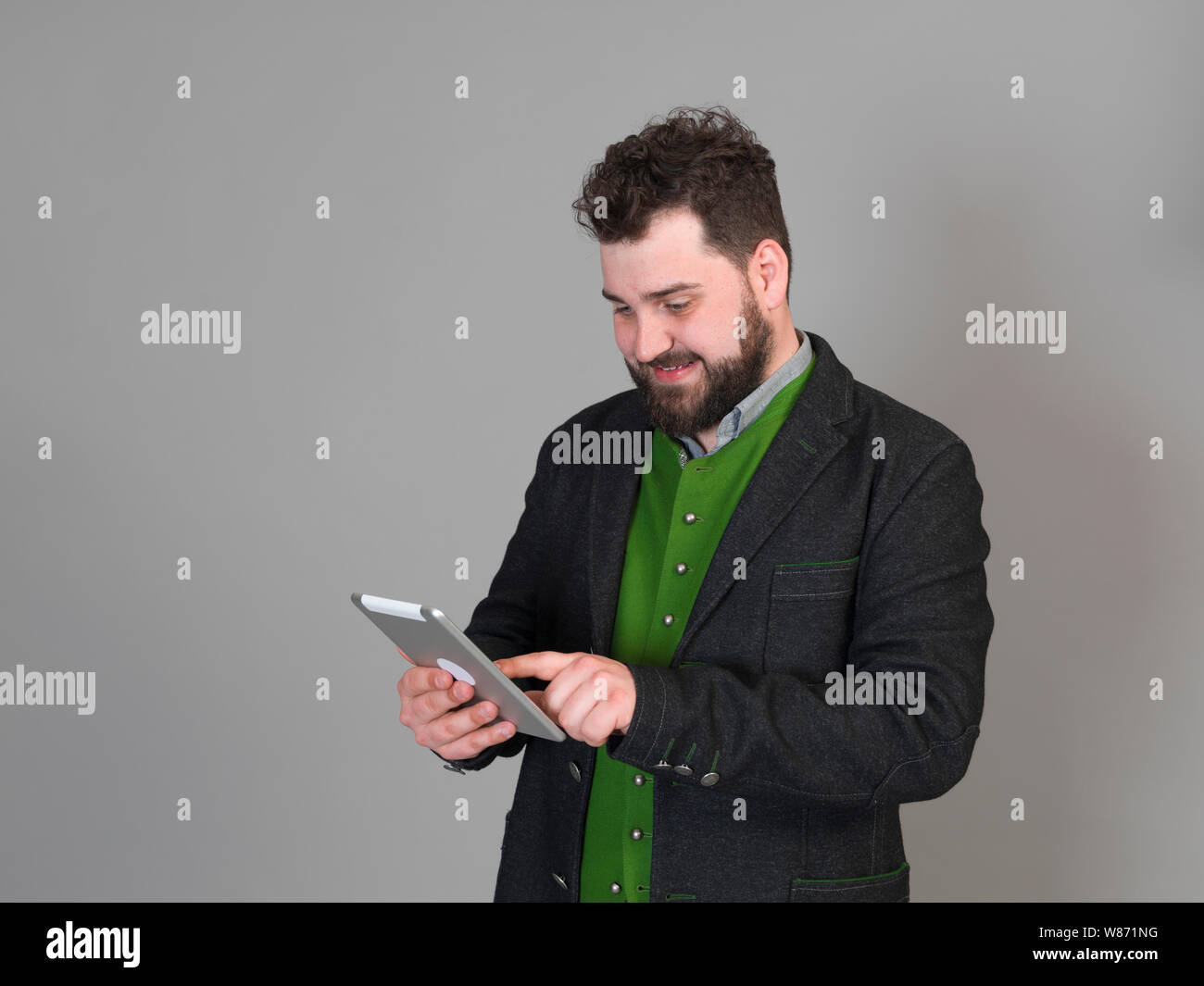 young and cool austrian man with black hair and beard in traditional ...