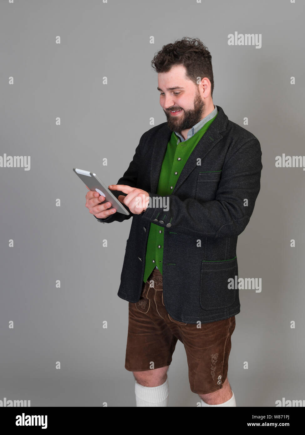 young and cool austrian man with black hair and beard in traditional ...