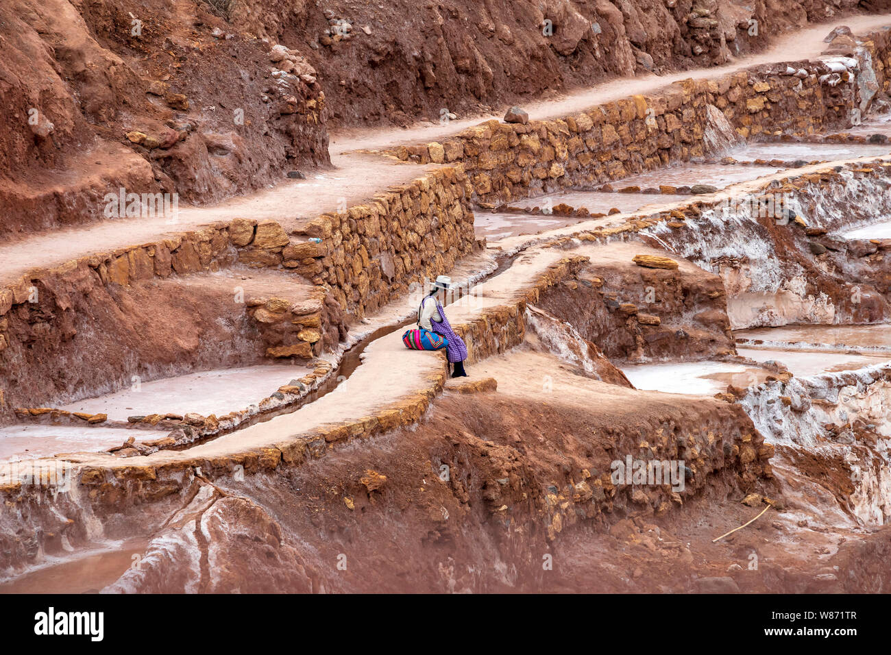 Quechua people working at the traditional inca salt field in Salinas de ...