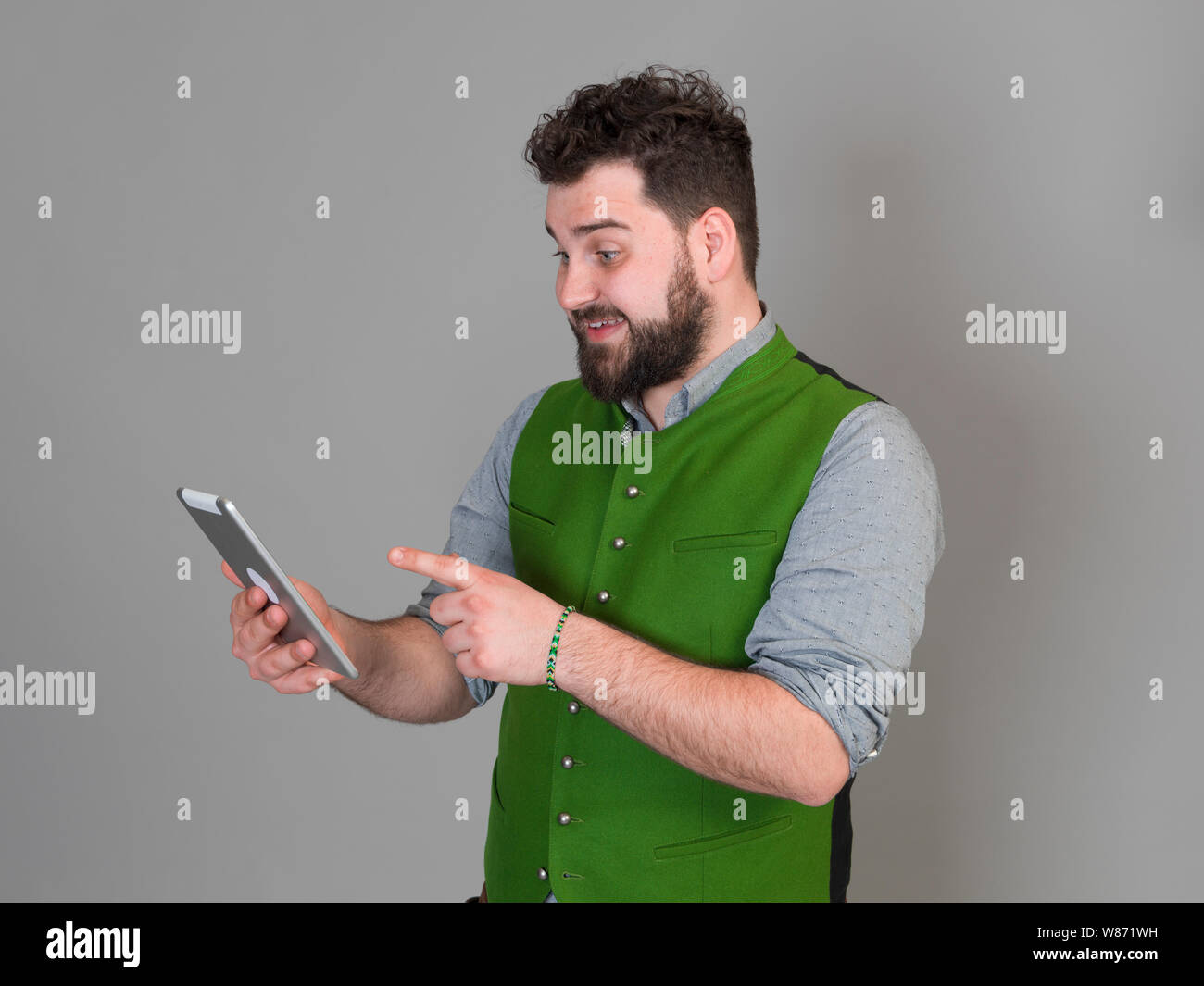 young and cool austrian man with black hair and beard in traditional ...