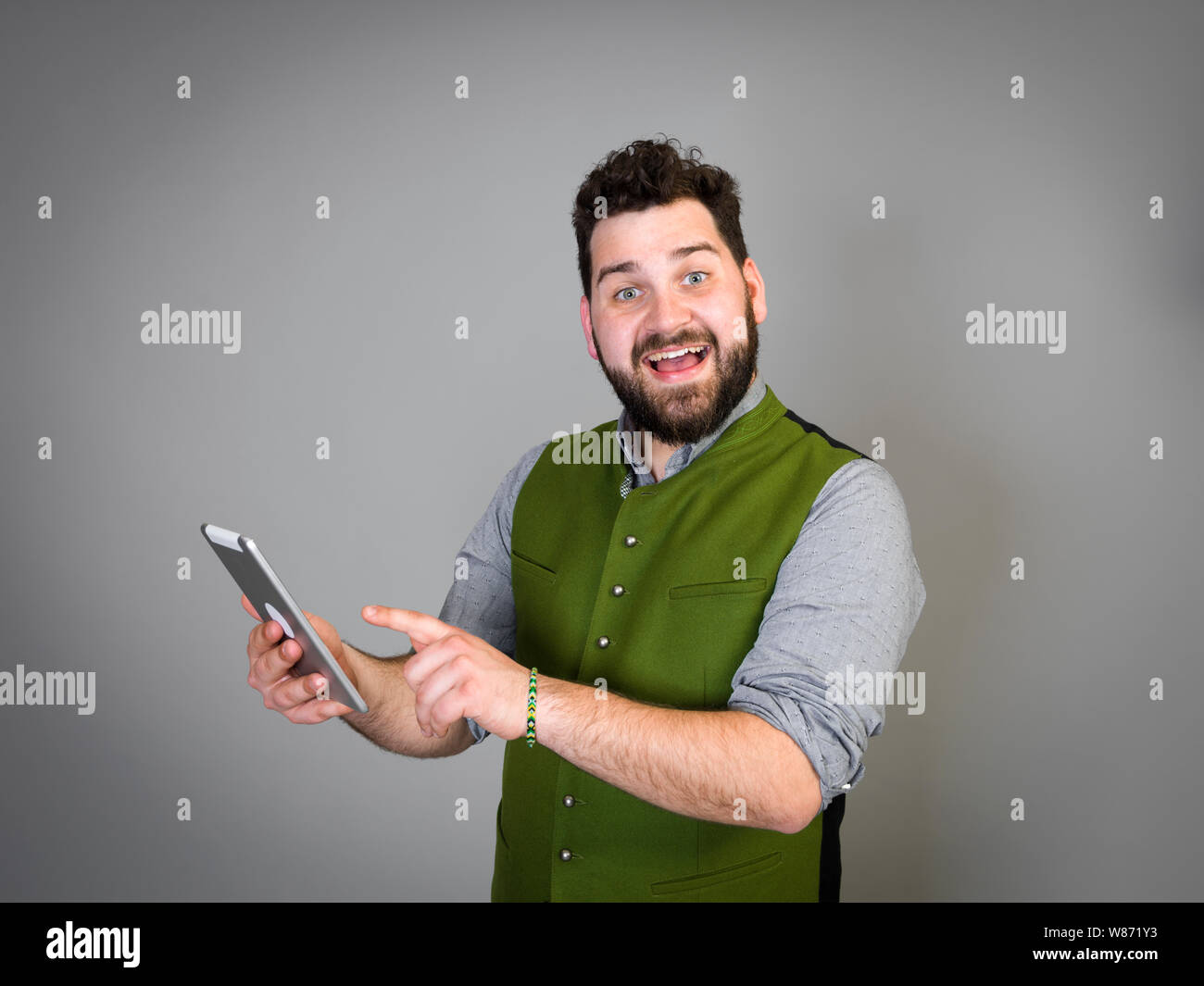young and cool austrian man with black hair and beard in traditional ...