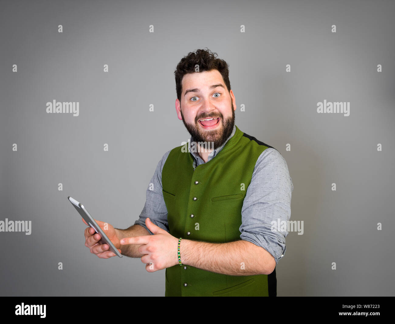 young and cool austrian man with black hair and beard in traditional ...