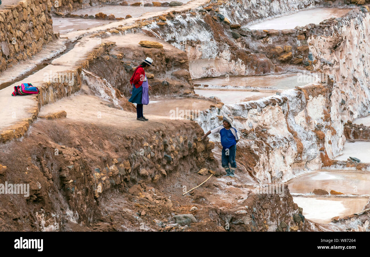 Quechua people working at the traditional inca salt field in Salinas de ...