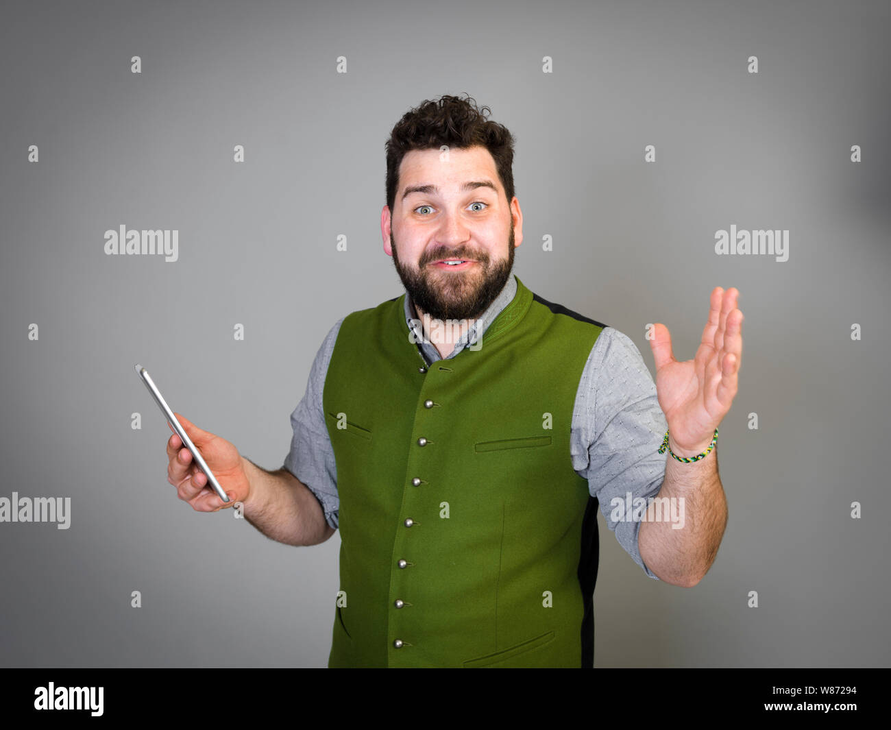 young and cool austrian man with black hair and beard in traditional ...