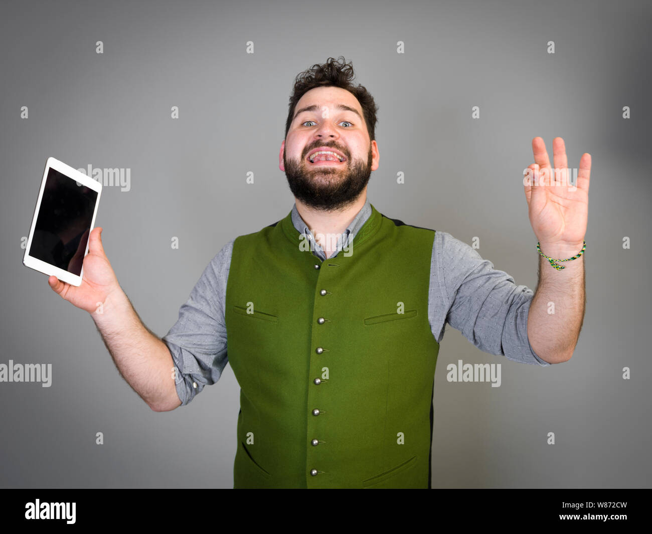 young and cool austrian man with black hair and beard in traditional ...