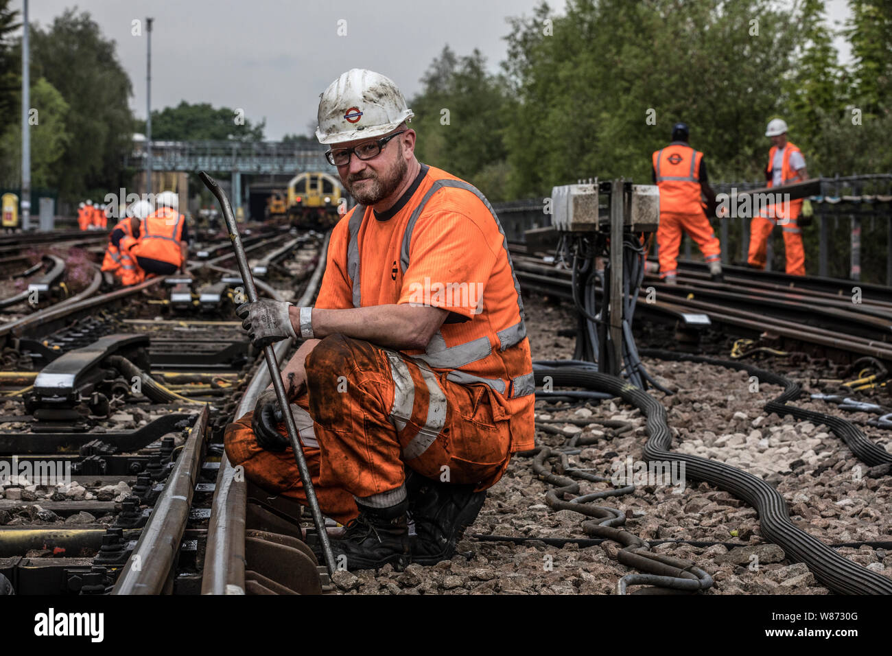 Maintenance team work on London Underground Central Line. Tack defect ...