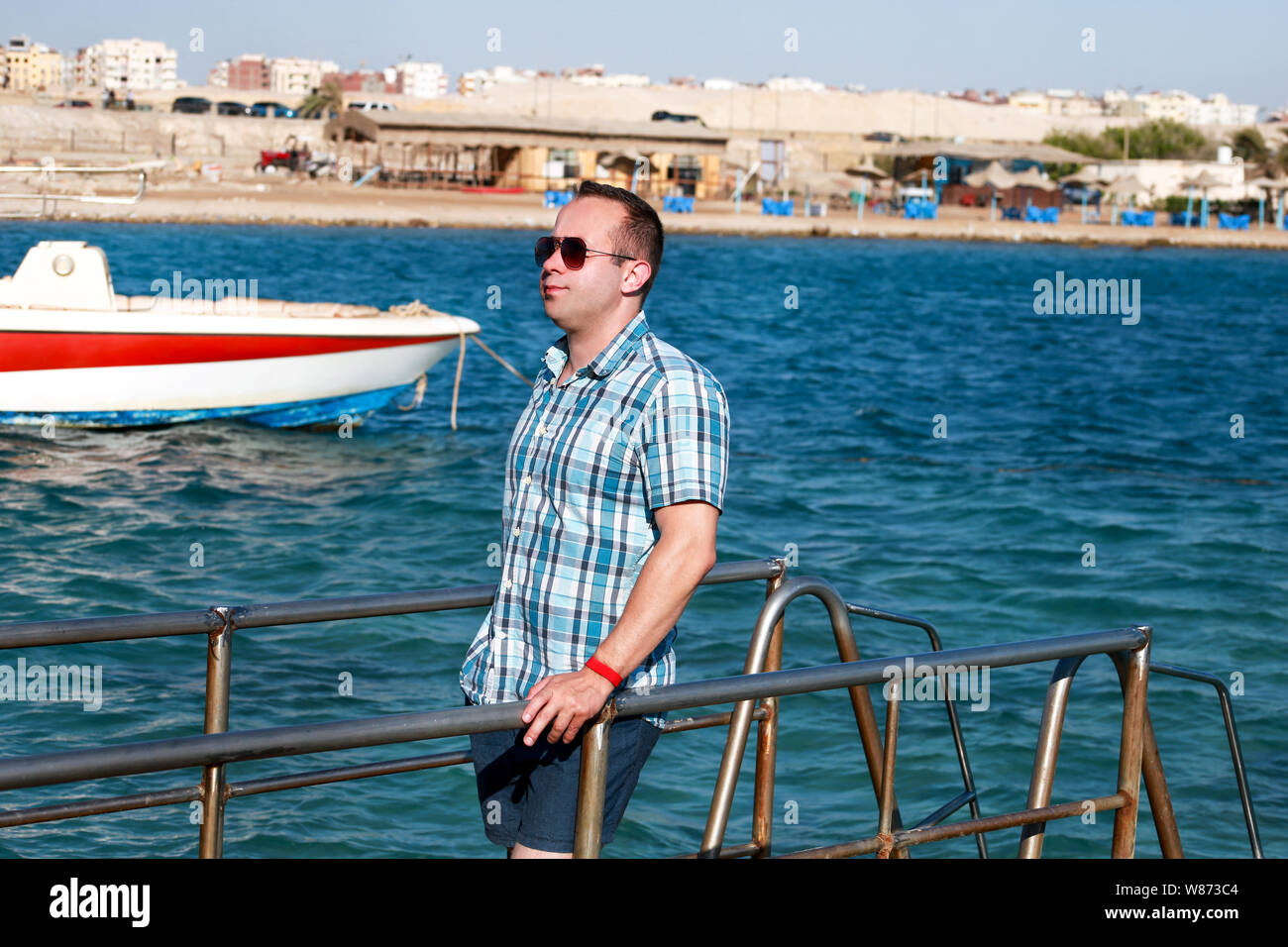 Portrait of tourist and traveler is posing and walking on beach pier ...