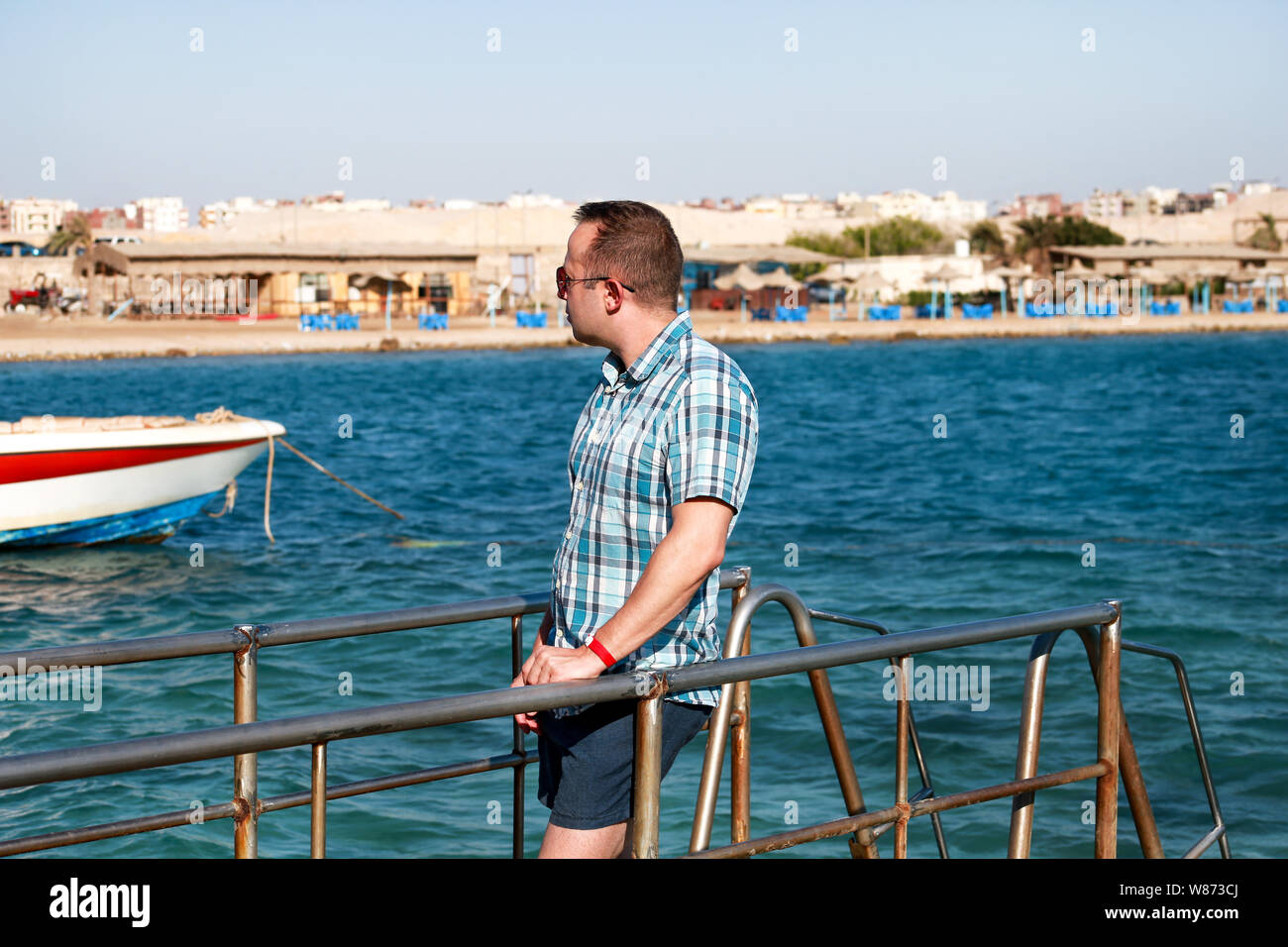 Portrait of tourist and traveler is posing and walking on beach pier ...