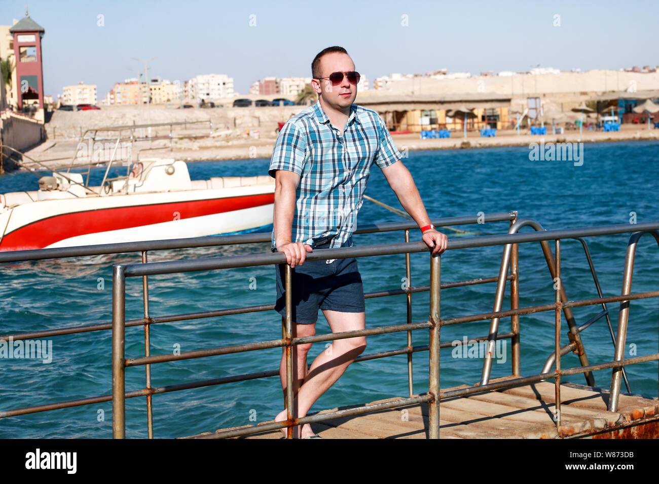 Portrait of tourist and traveler is posing and walking on beach pier ...