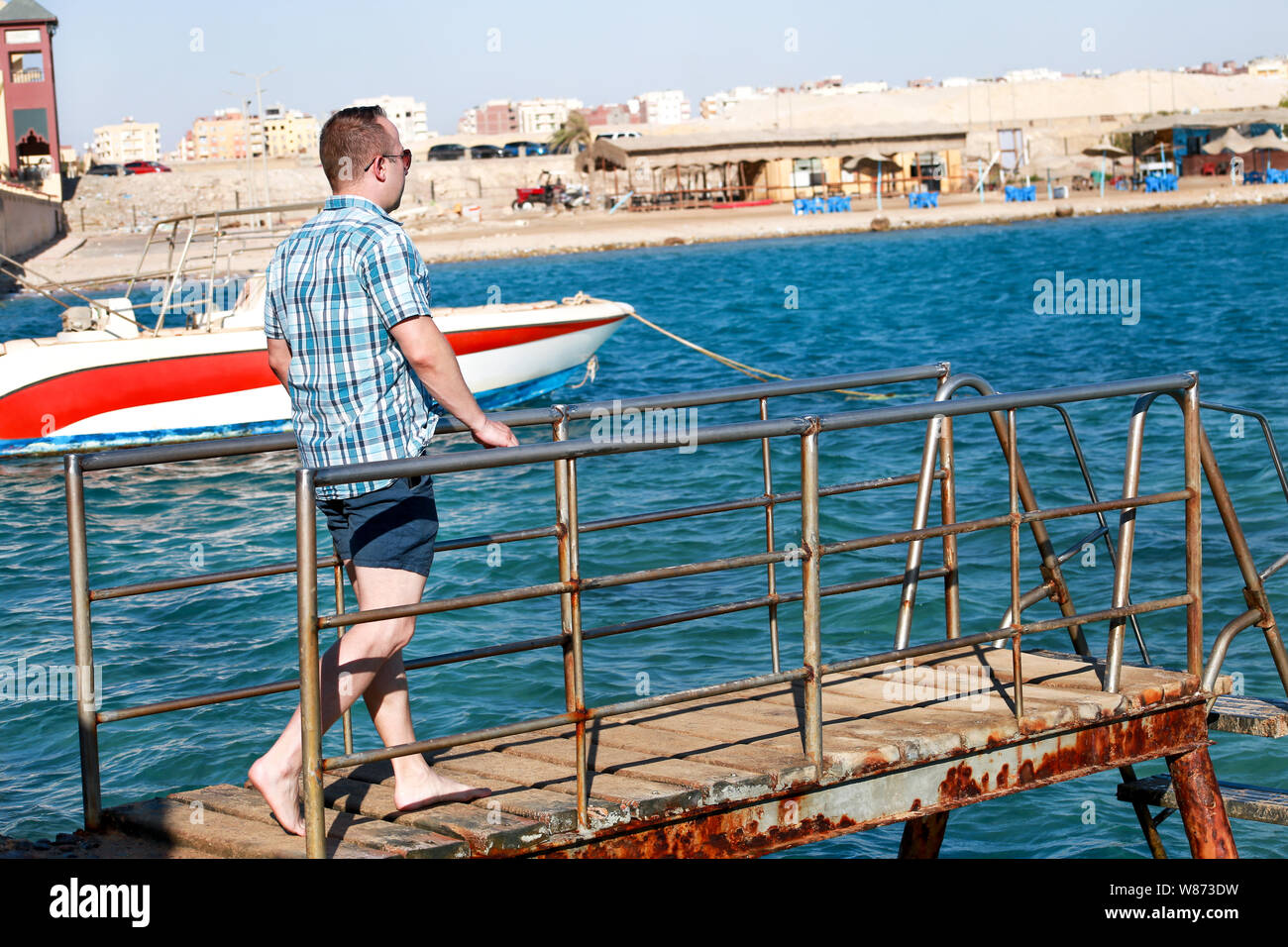 Portrait of tourist and traveler is posing and walking on beach pier ...