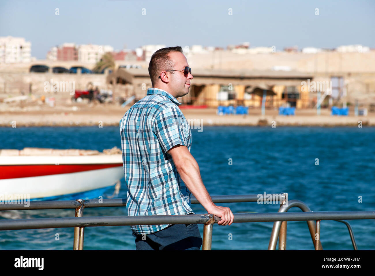 Portrait of tourist and traveler is posing and walking on beach pier ...