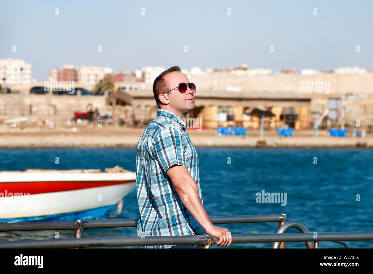 Portrait of tourist and traveler is posing and walking on beach pier ...