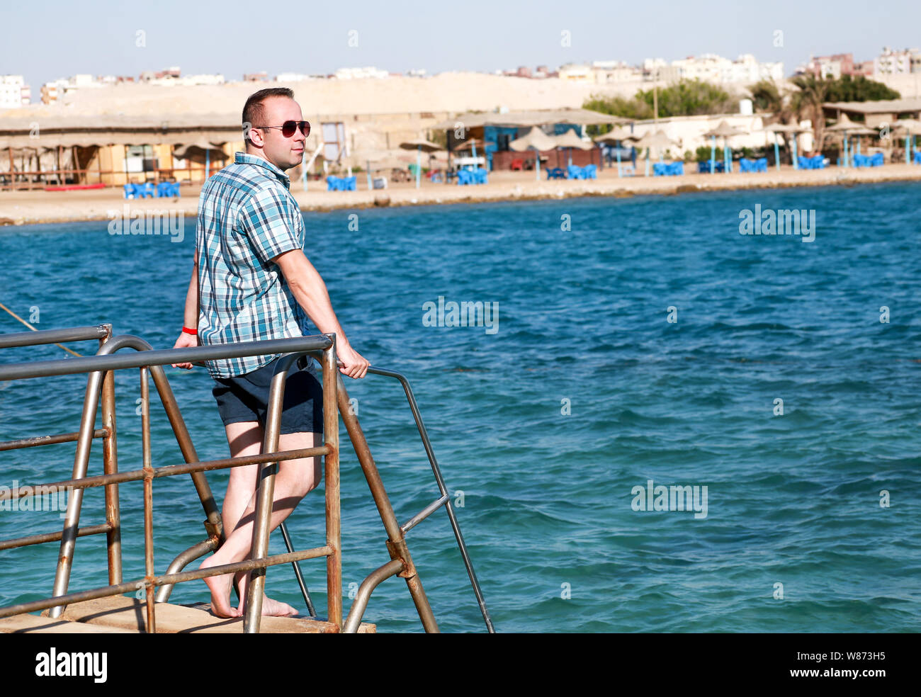 Portrait of tourist and traveler is posing and walking on beach pier ...