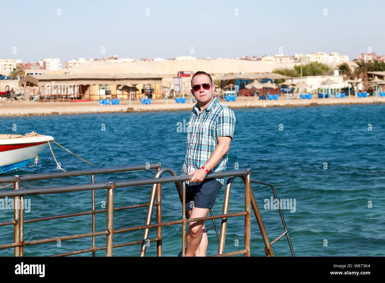 Portrait of tourist and traveler is posing and walking on beach pier ...