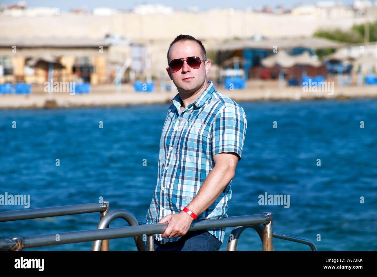 Portrait of tourist and traveler is posing and walking on beach pier ...