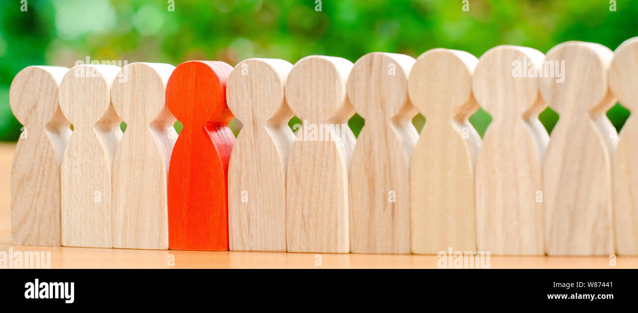 Wooden figures of people. The red man comes out with a team of workers ...