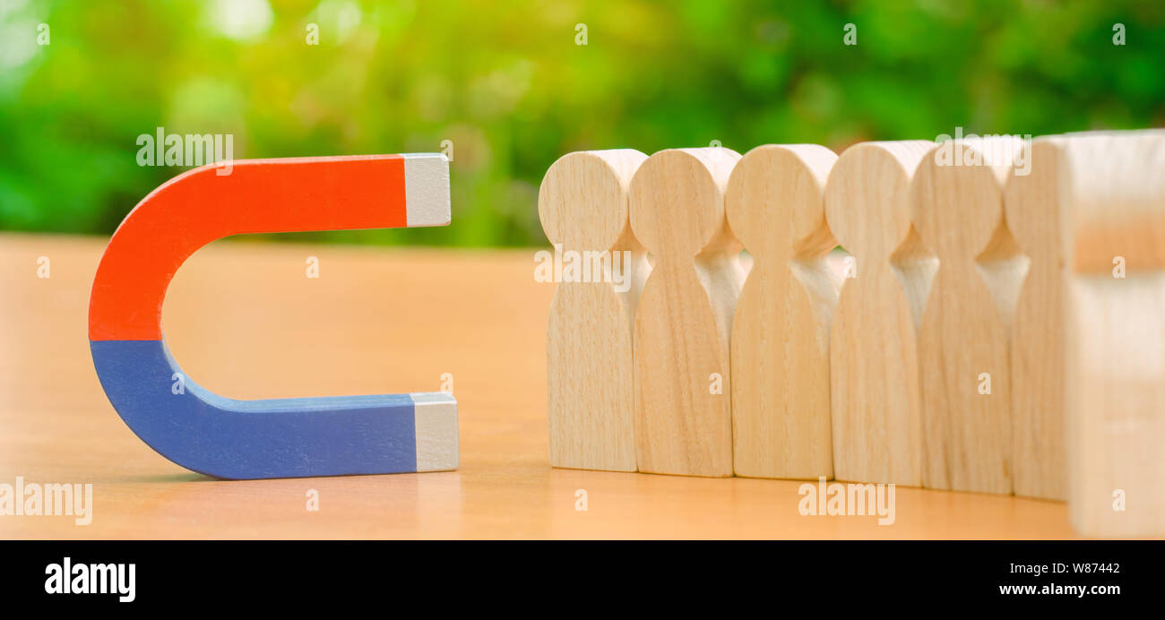 Wooden figures of people and a magnet. Team management concept. Human ...