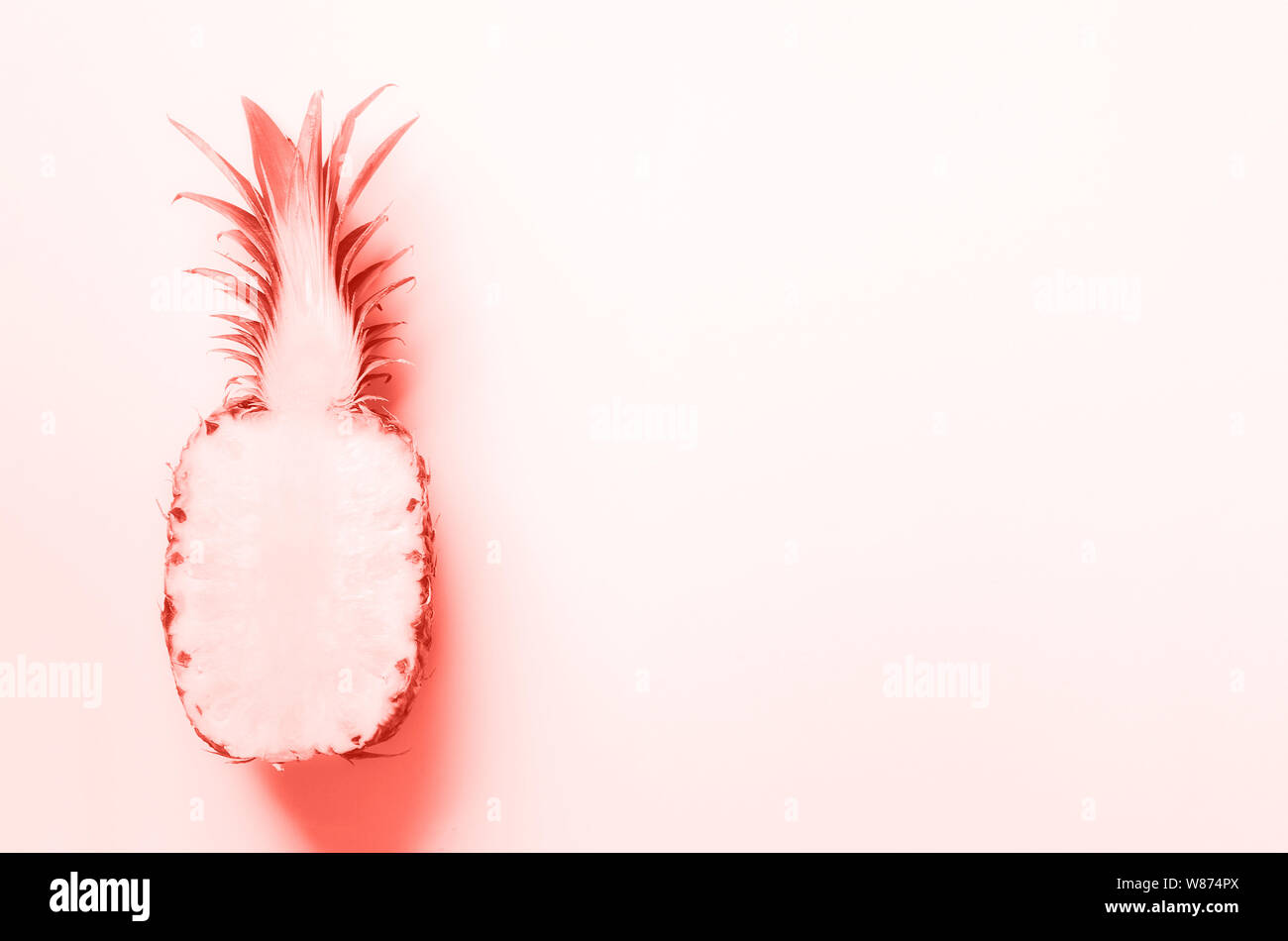 Half of sliced pineapple on trendy coral color background. Top View ...