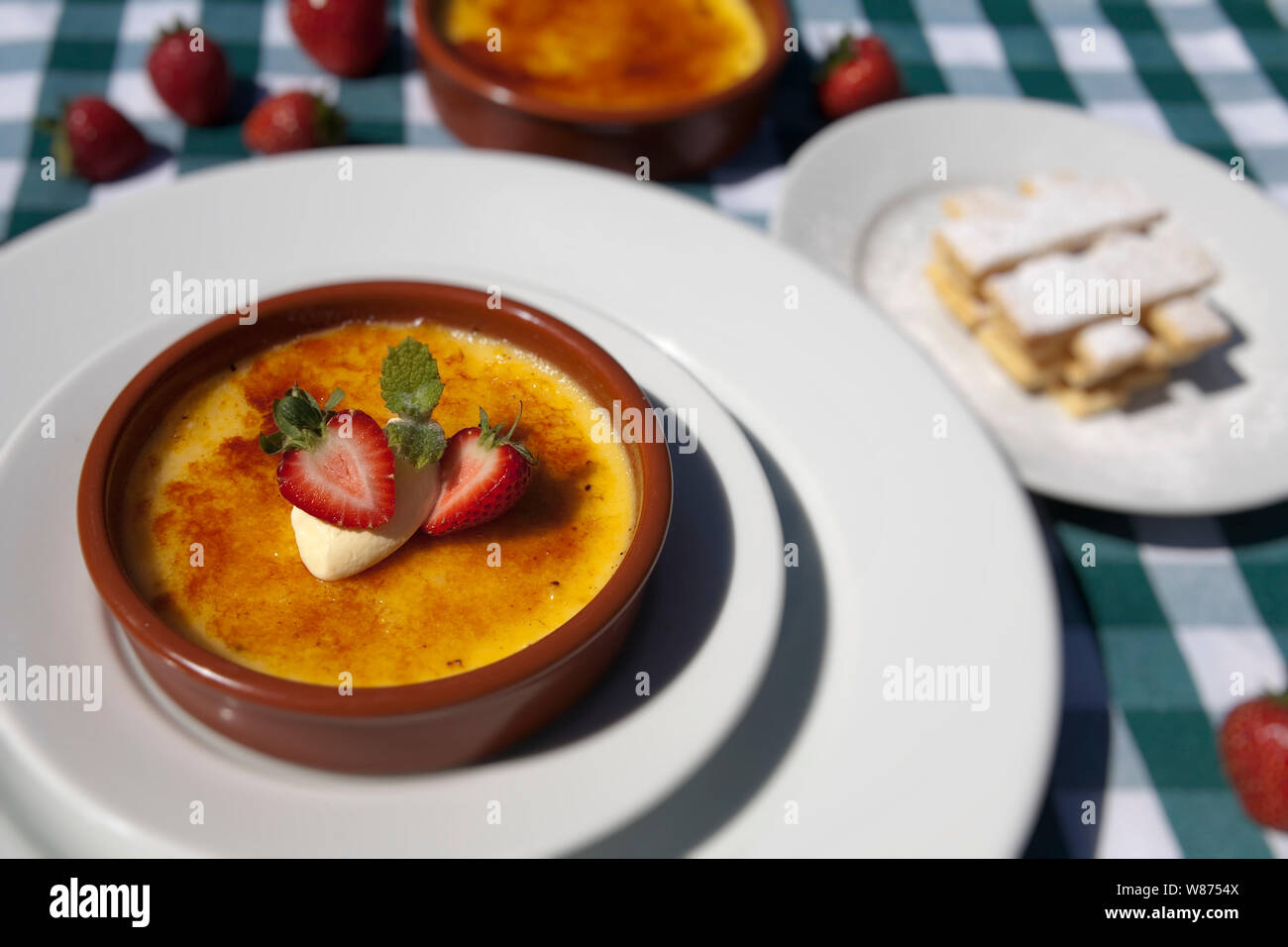 creme brulee served al fresco with strawberries and cream and ...