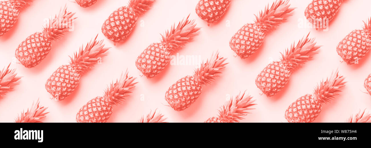 Fresh pineapples on trendy coral color background. Top View. Pop art ...