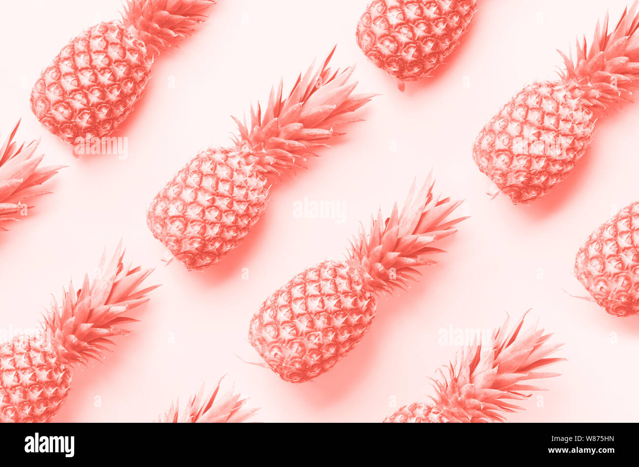 Fresh pineapples on trendy coral color background. Top View. Pop art ...