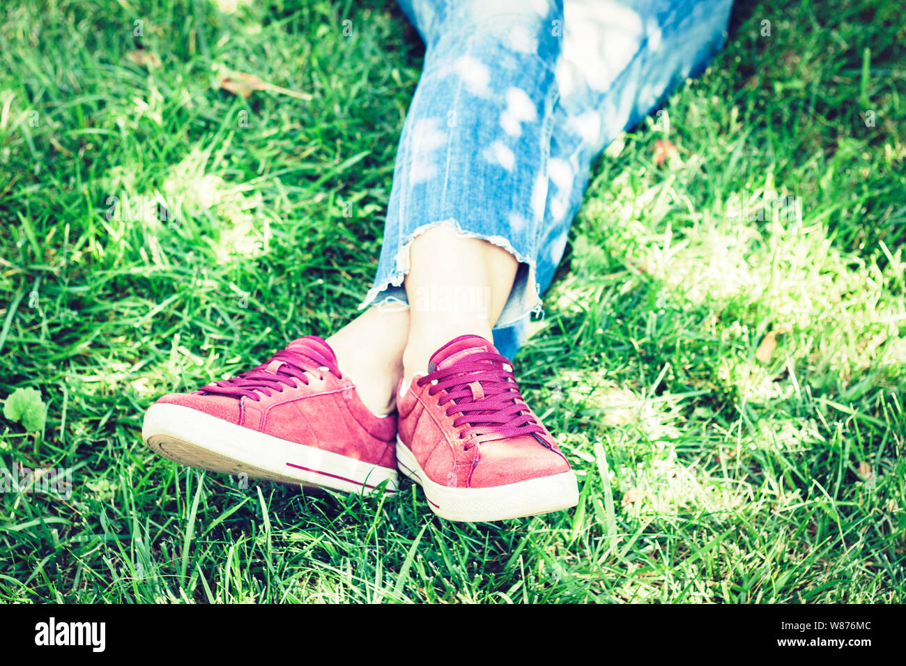 Woman walking grass trainers hi-res stock photography and images - Alamy