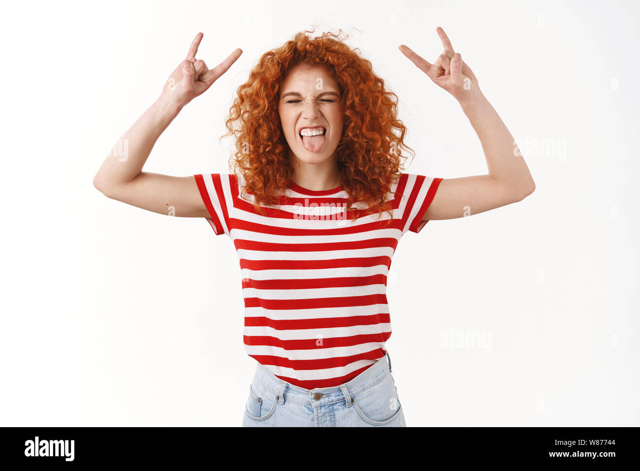 Heavy metal rock party. Playful carefree happy redhead curly-haired ...