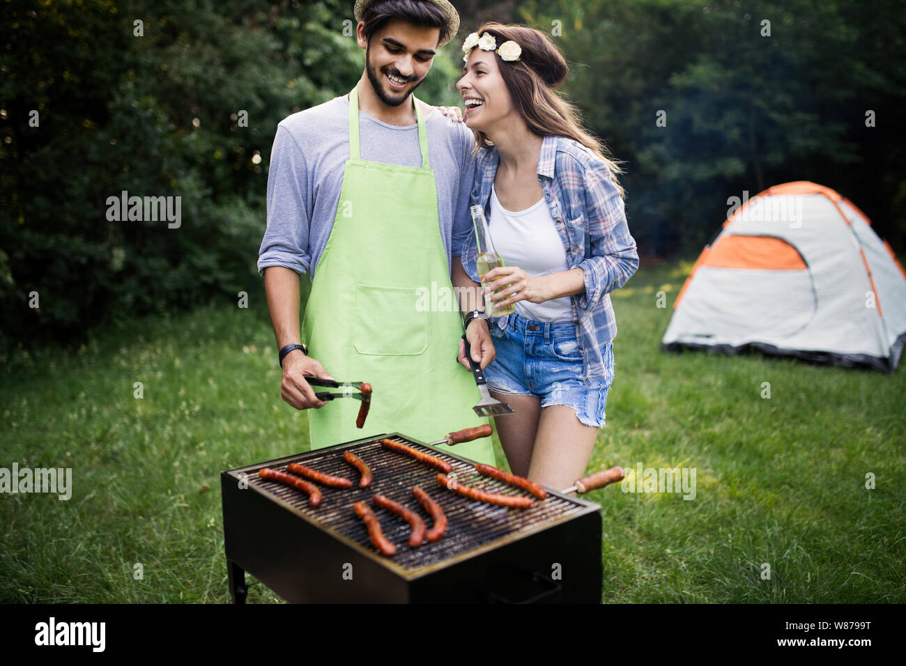 Group of friends making barbecue in the nature Stock Photo - Alamy