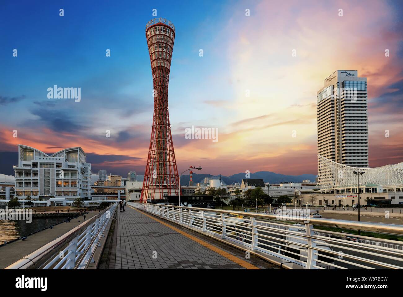 Kobe pedestrian bridge and metallic tower at sunset, Japan Stock Photo ...