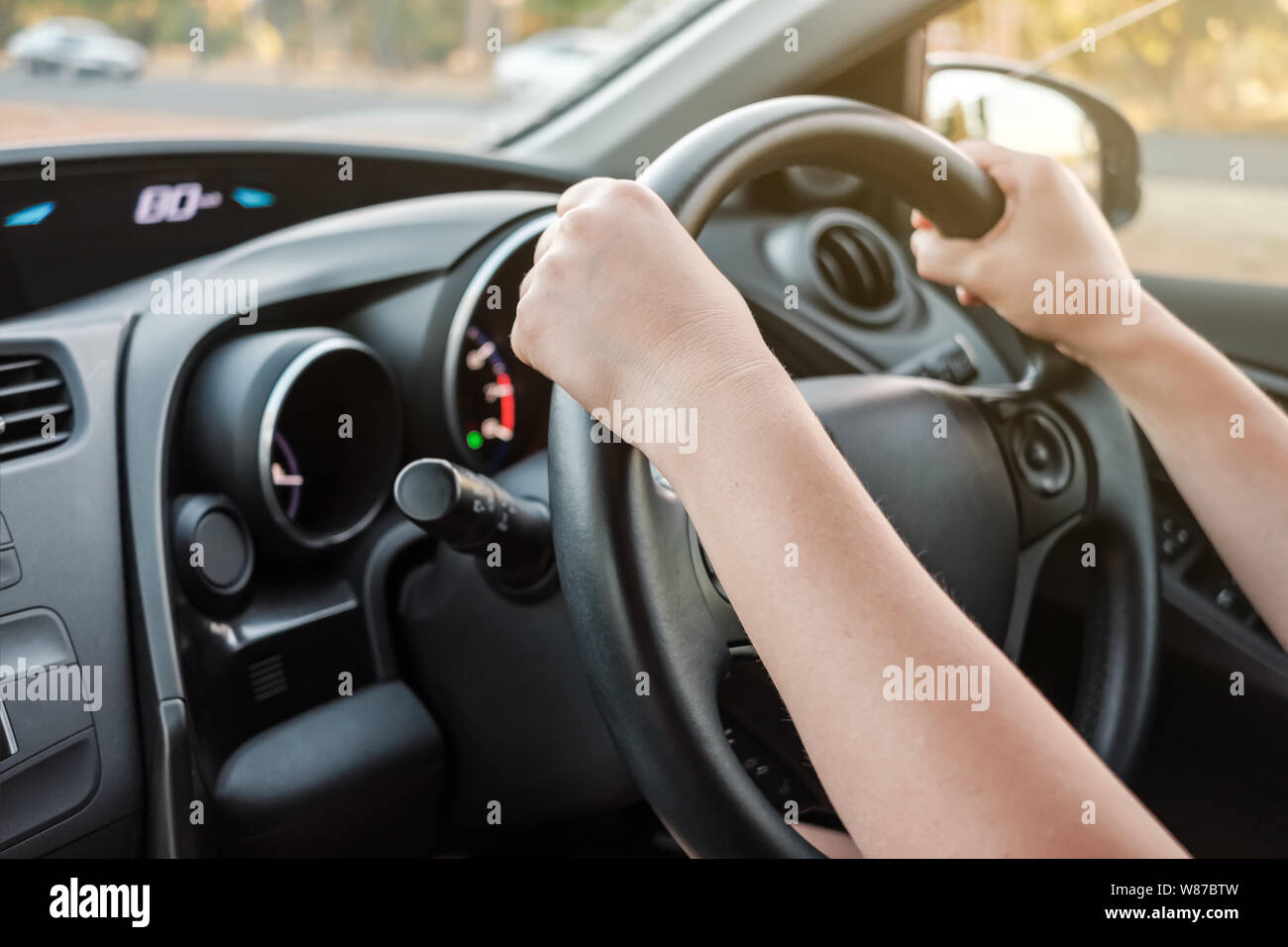 Woman driving her car with both hands on steering wheel Stock Photo - Alamy