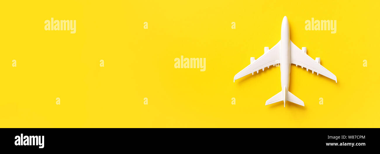 White plane, airplane on yellow color background with copy space. Top ...