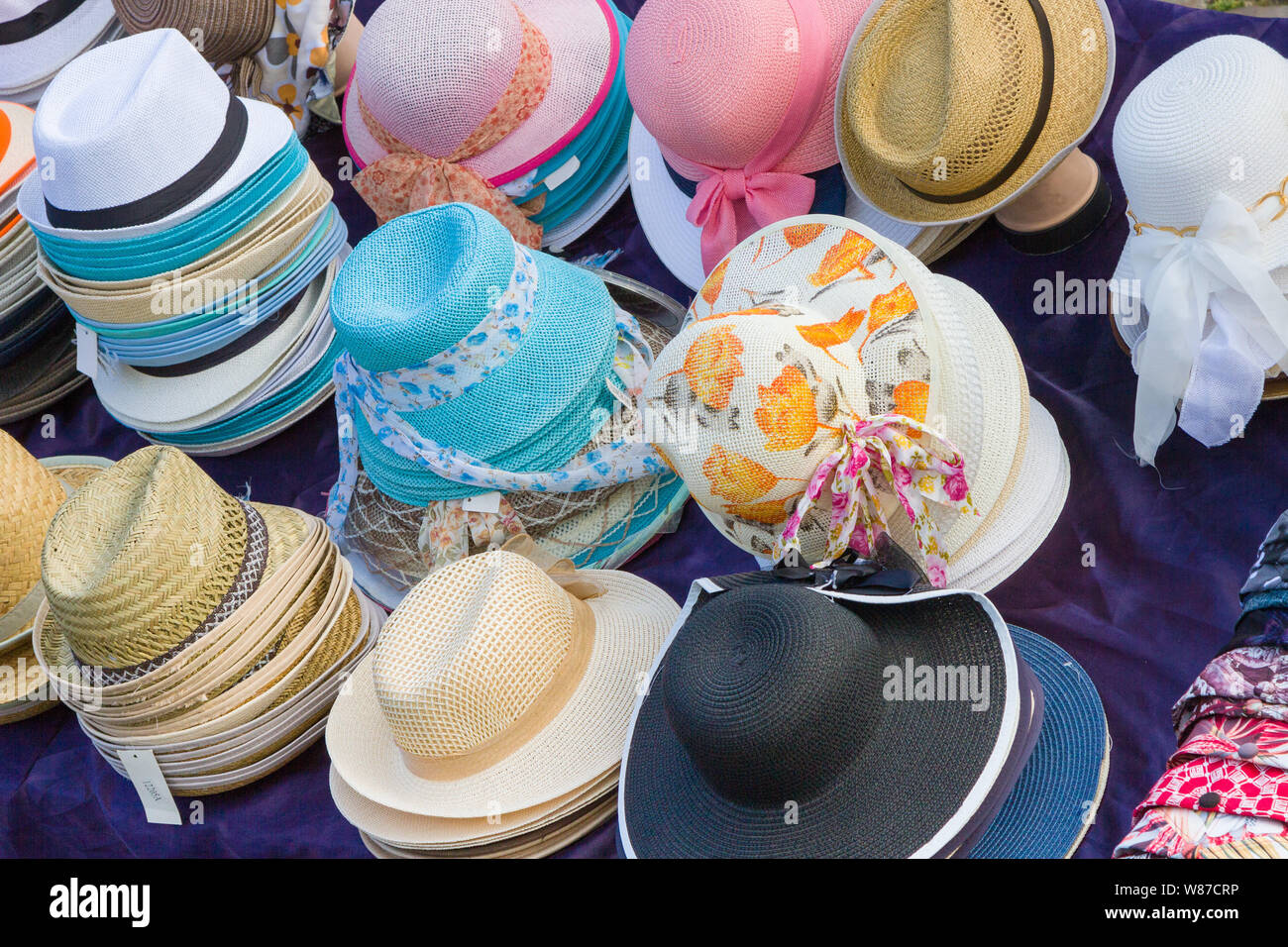 Colourful hats for sale on a stall in the Saturday market in Honfleur ...