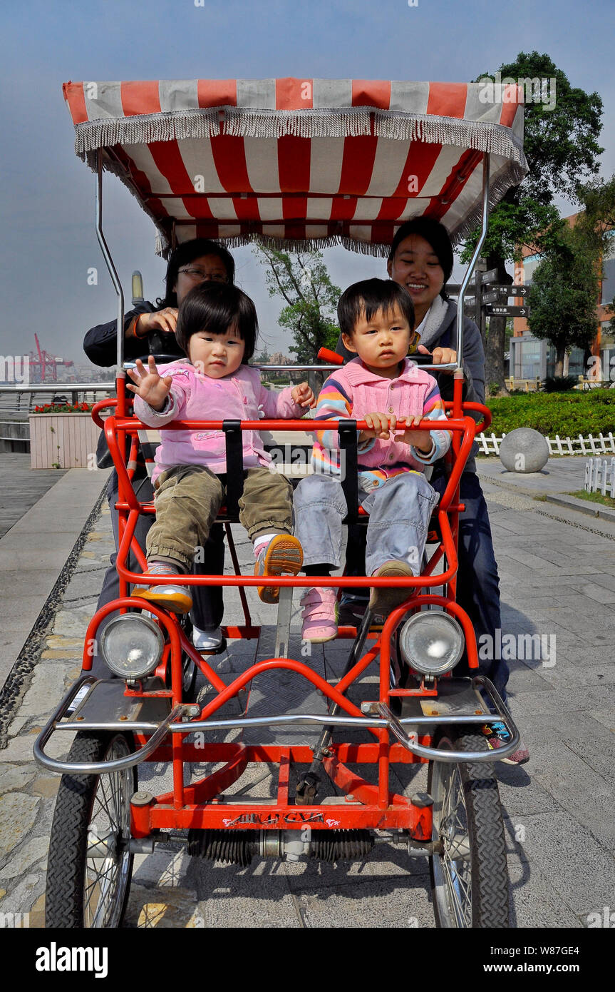 Young Chinese mothers ride a buggy with their children Stock Photo - Alamy