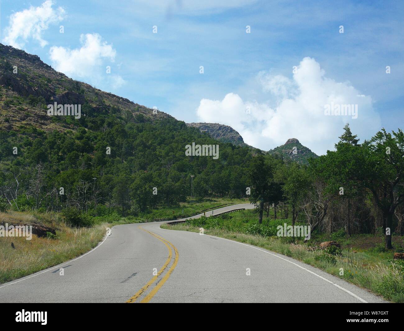 Paved winding road around the Wichita Mountains National area in ...