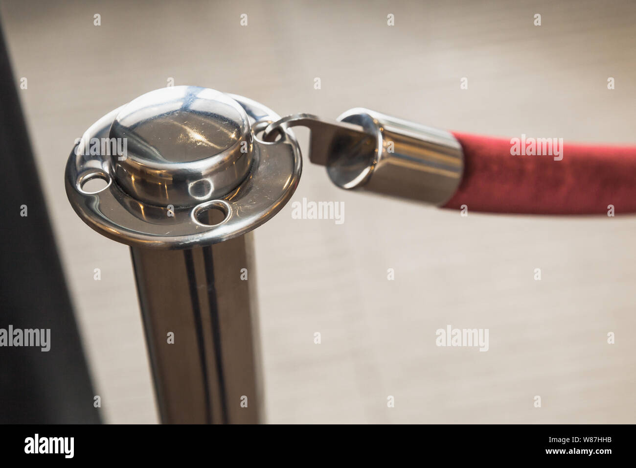 Red rope barrier at a club entrance, close up photo with soft selective ...
