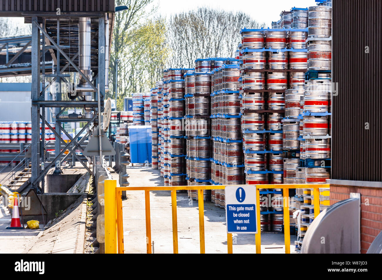Rows of beer kegs stored on pallets at a brewery manufacturing plant ...