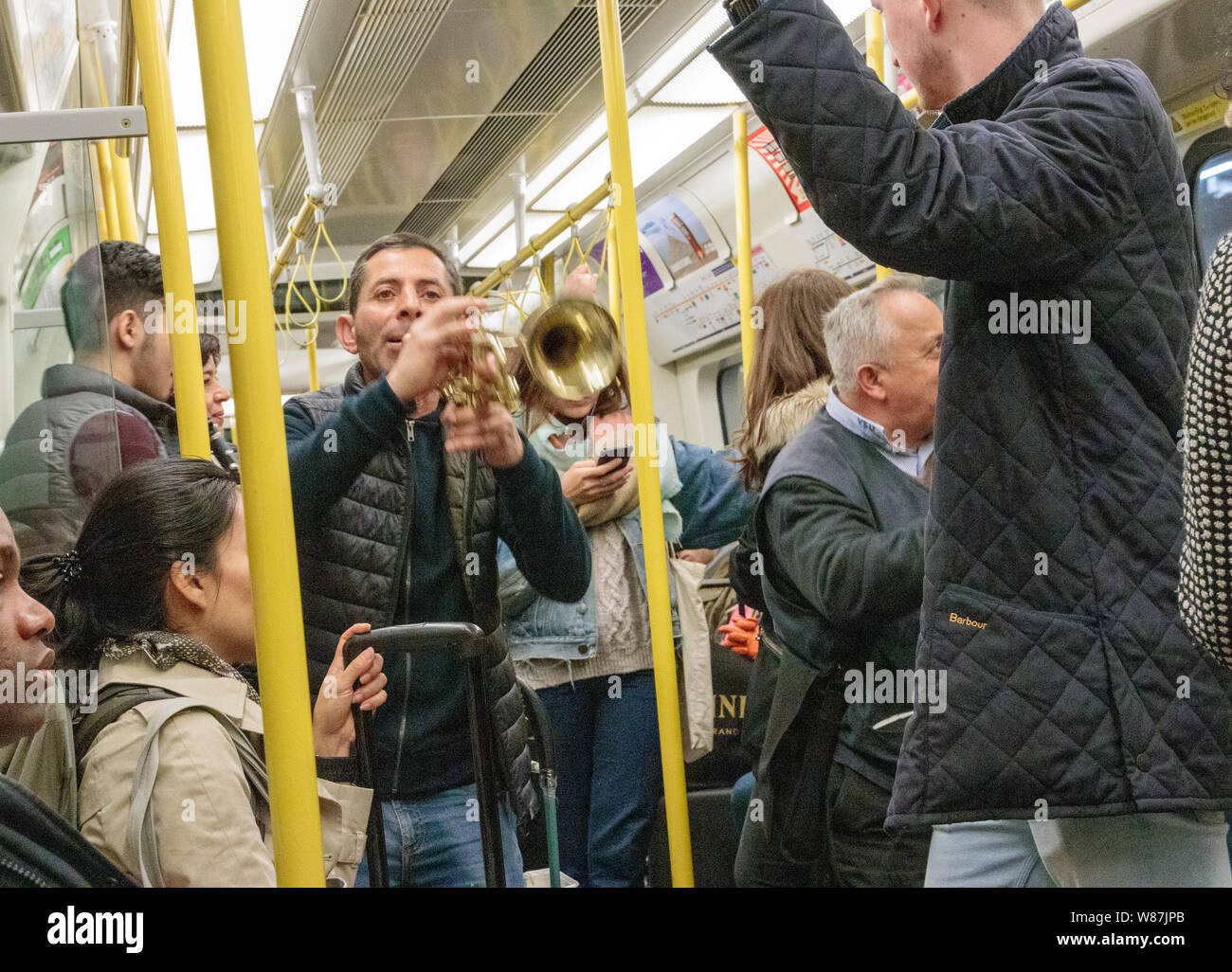 Unidentified people busking on the London Underground Stock Photo - Alamy