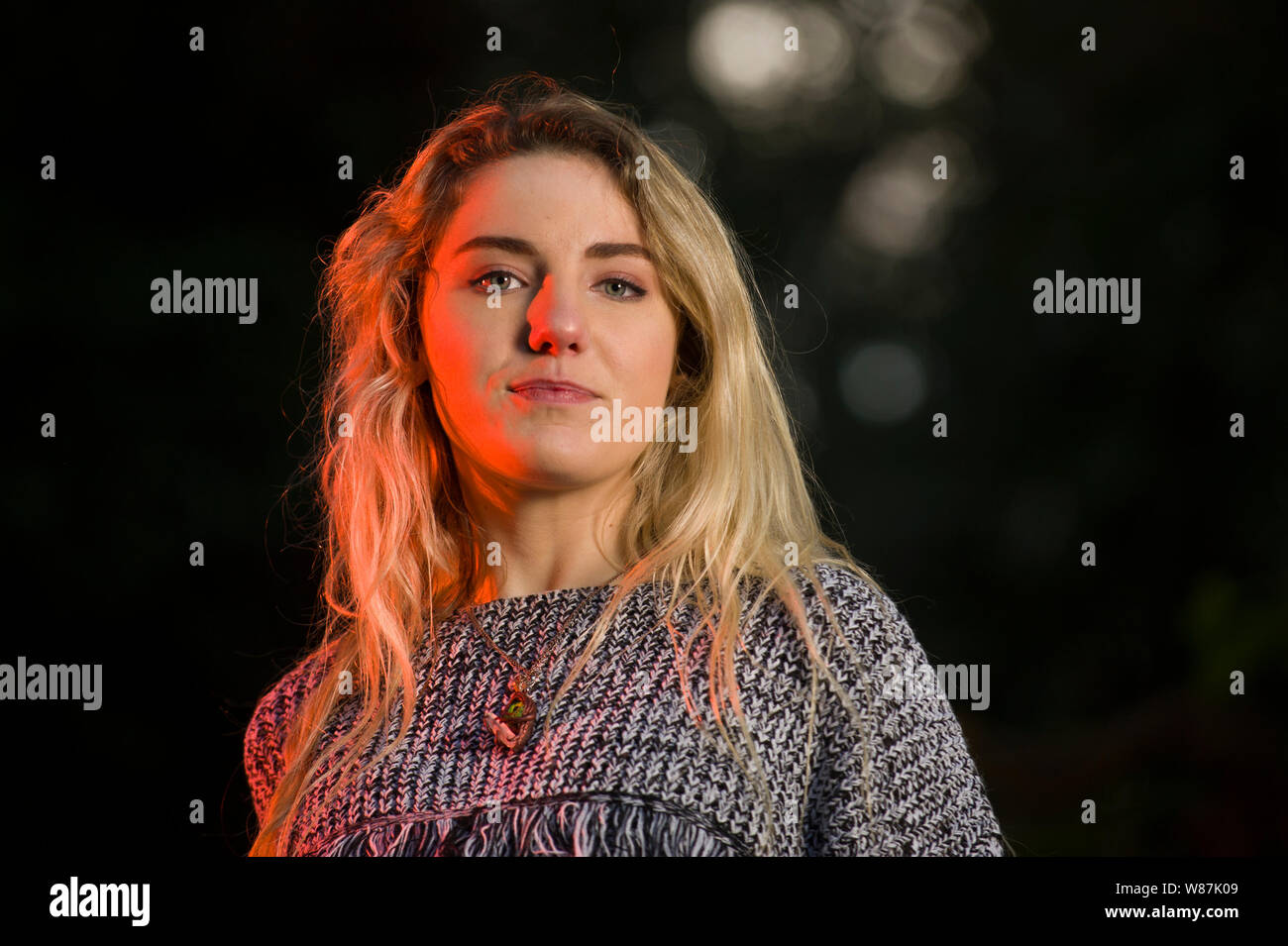 Girl looks directly into the camera, in a dramatic pose, and creative ...